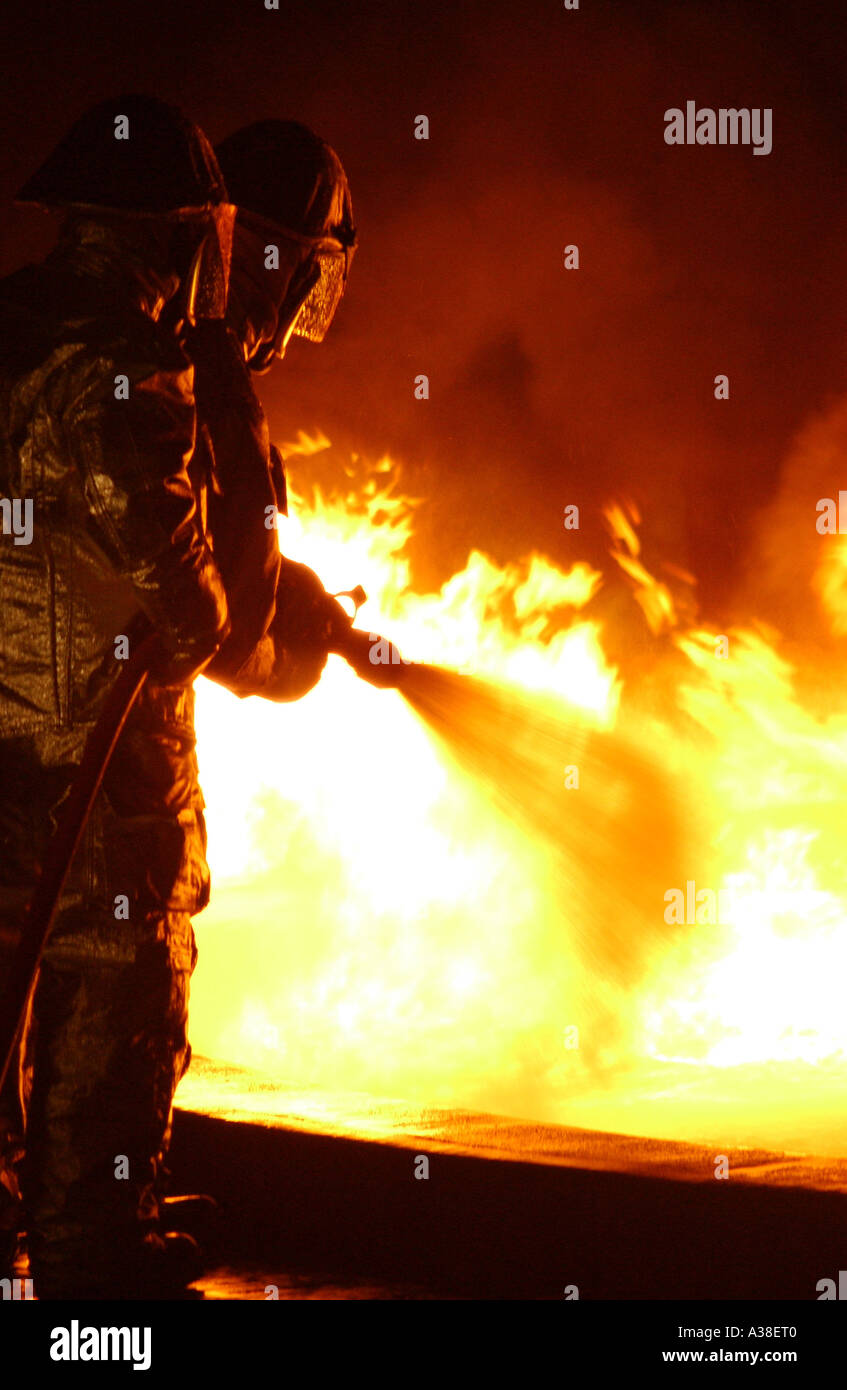 Firefighters struggle to extinguish blazing fire Stock Photo - Alamy