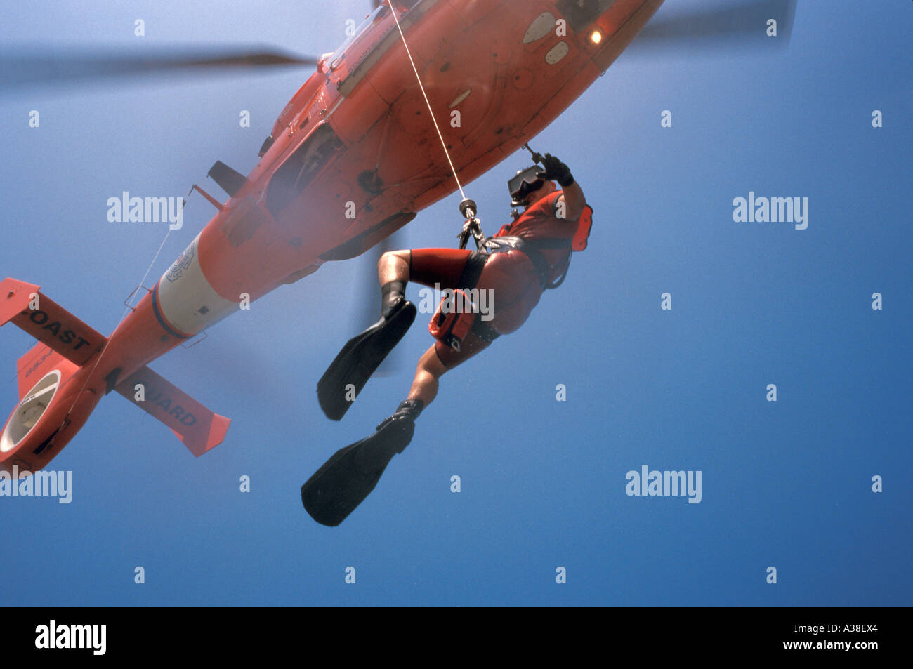 Coast guard rescue as man descends on rope from helicopter Stock Photo ...