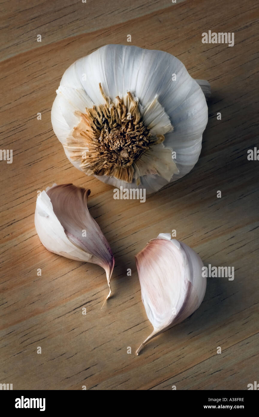 Whole Garlic with two cloves on a wood background Stock Photo - Alamy