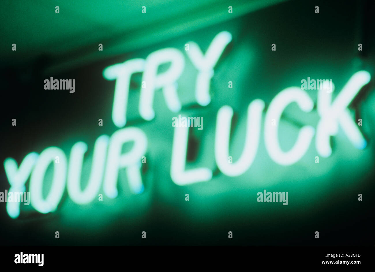 Defocussed green neon sign challenging public Try your Luck Stock Photo ...