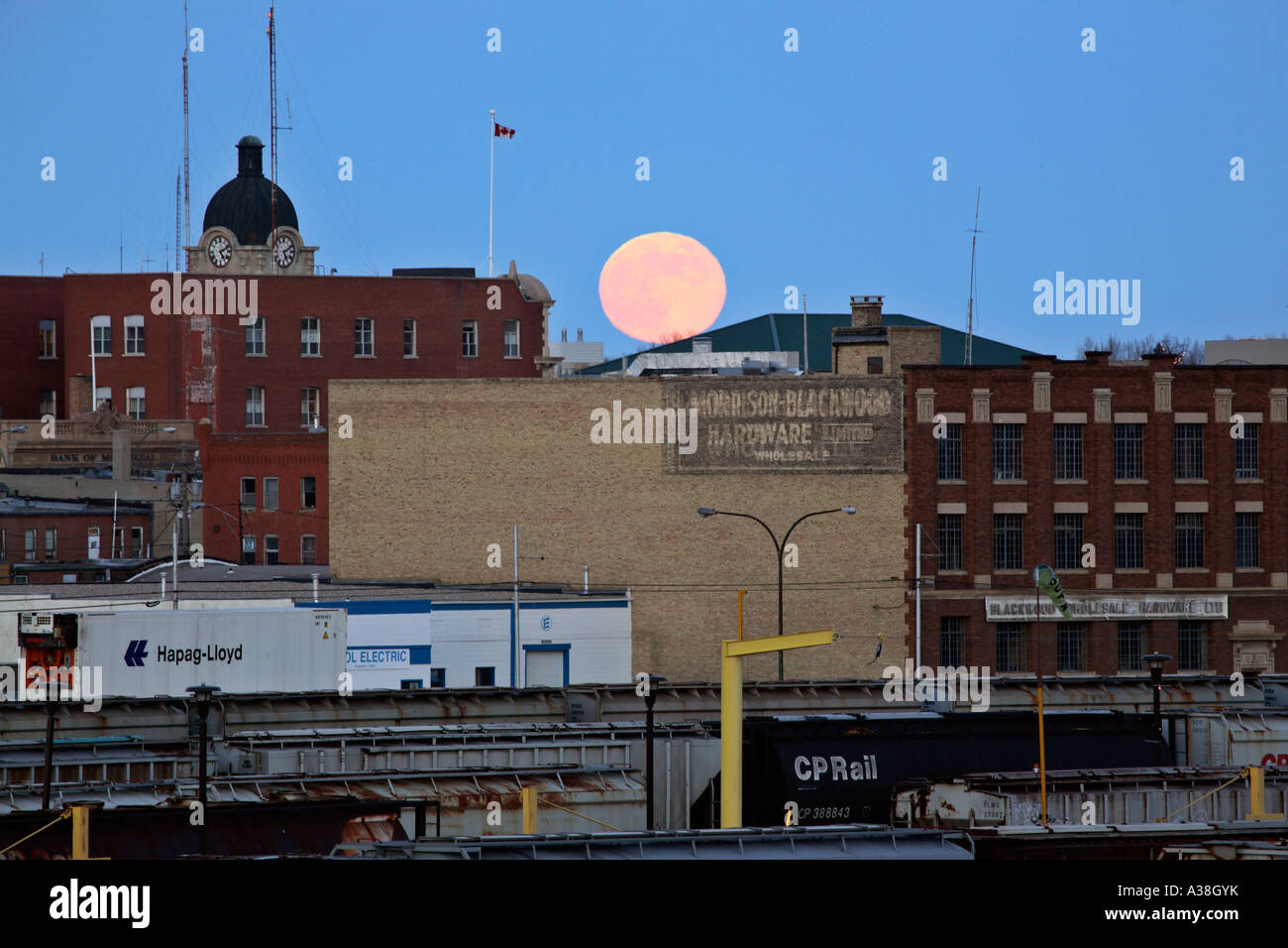 full moon rising over city building Stock Photo - Alamy