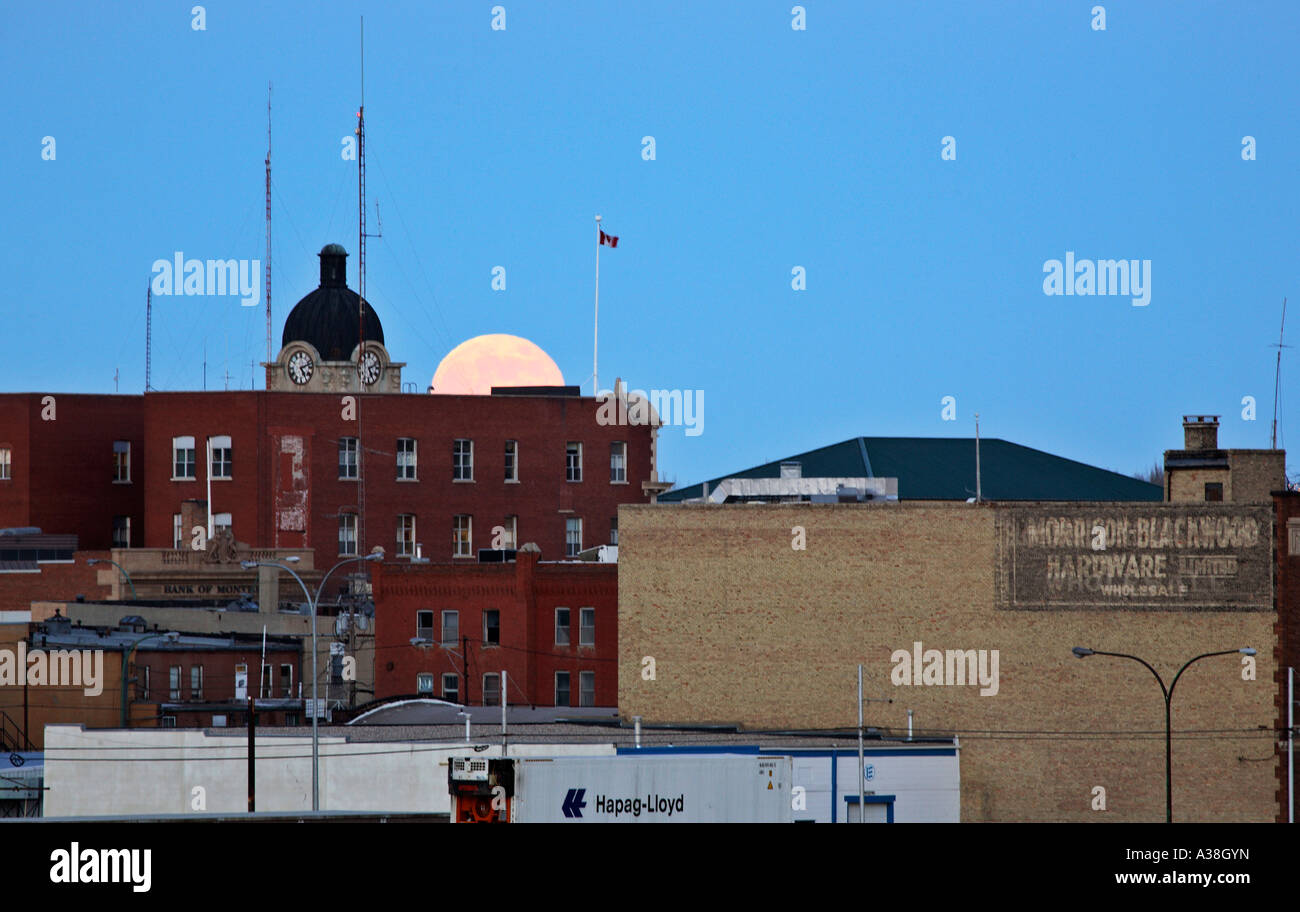 full moon rising over city building Stock Photo - Alamy