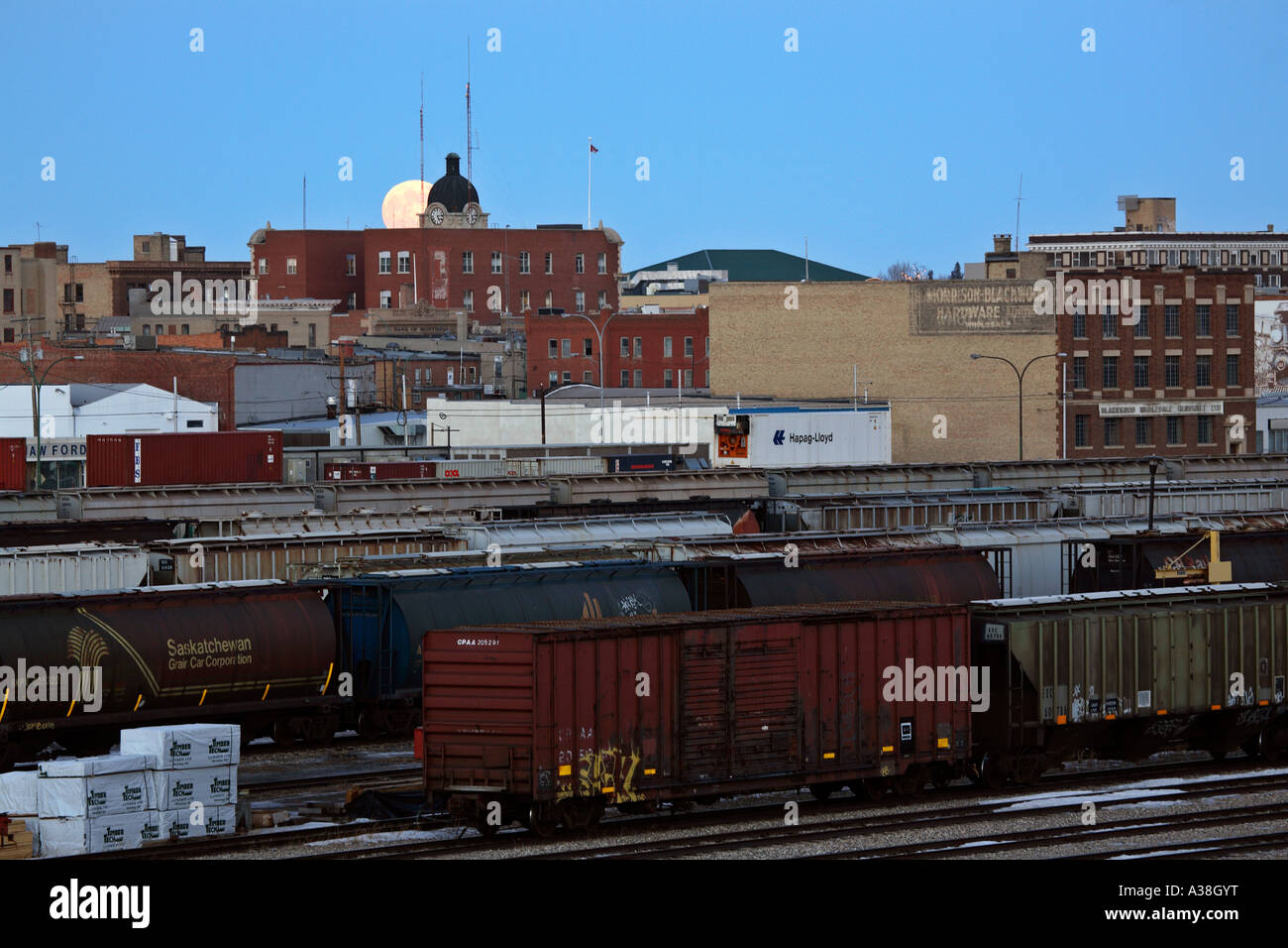 full moon rising over buildings Stock Photo - Alamy