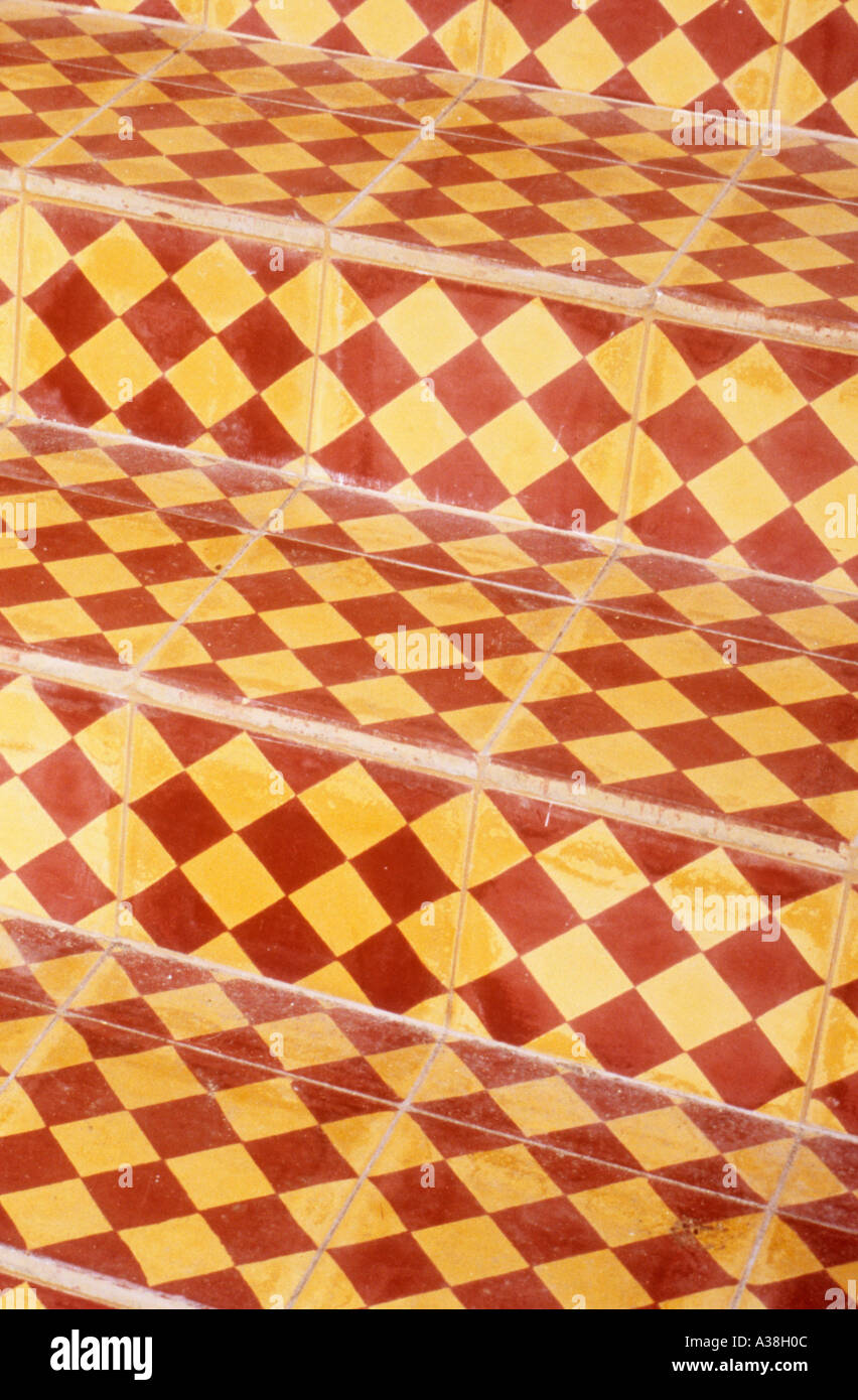Steps or stairway decorated with orange and cream diamond pattern tiles ...