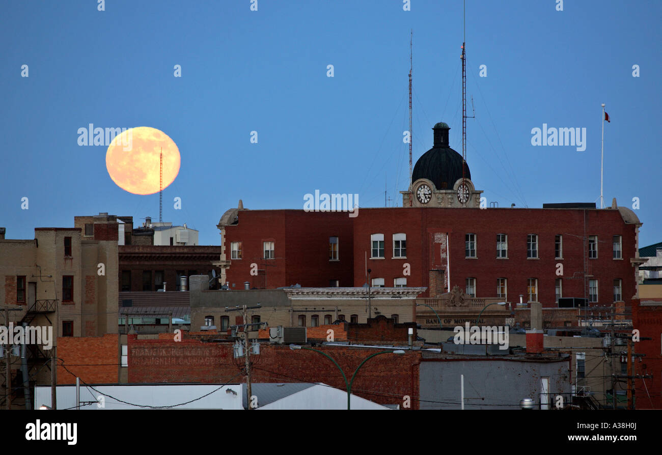 full moon over buildings Stock Photo - Alamy