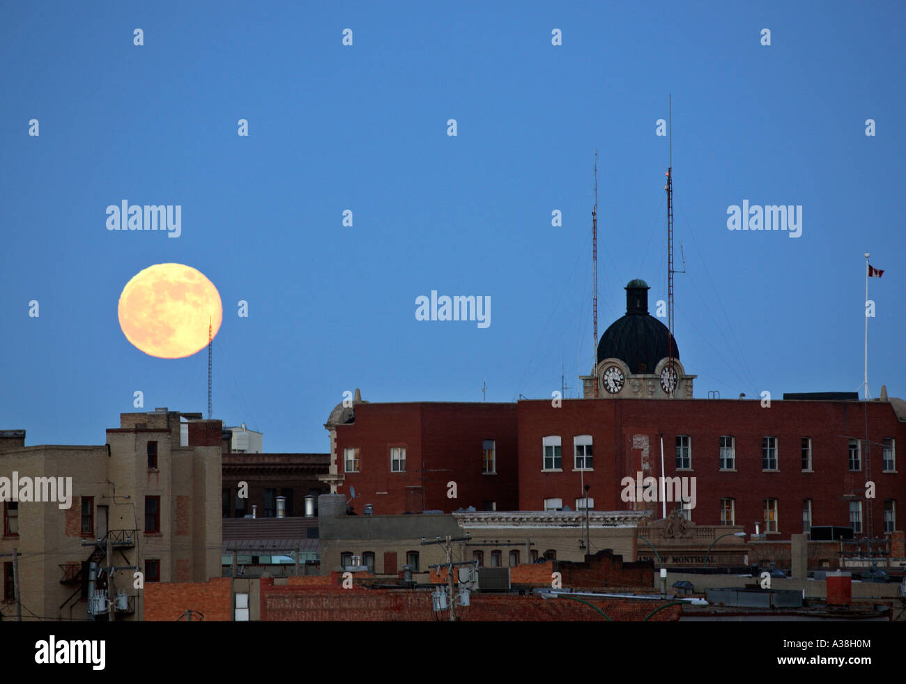 full moon over buildings Stock Photo - Alamy