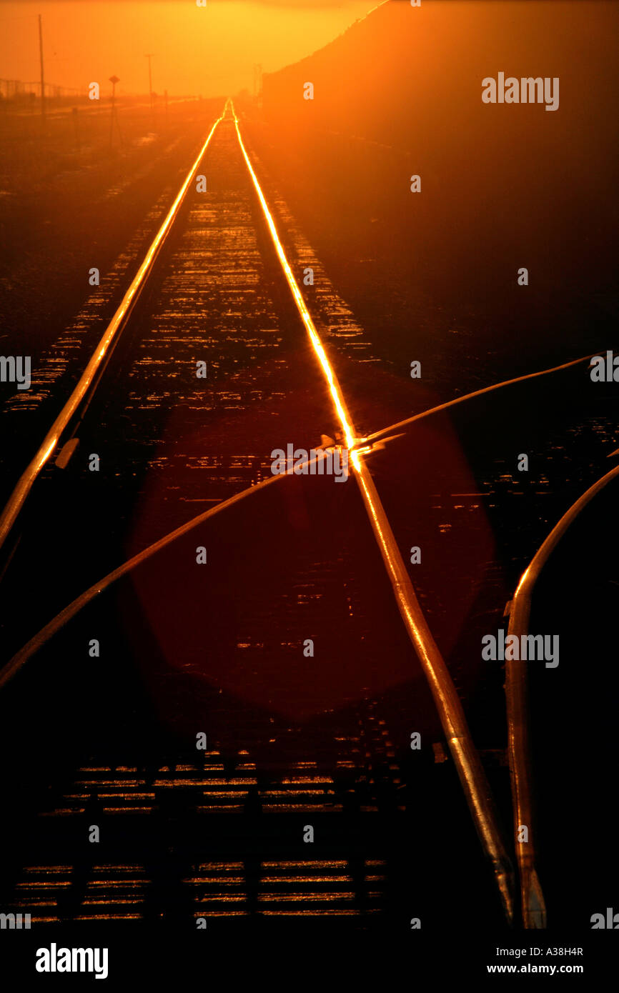 Morning sun lighting up railroad track Stock Photo - Alamy