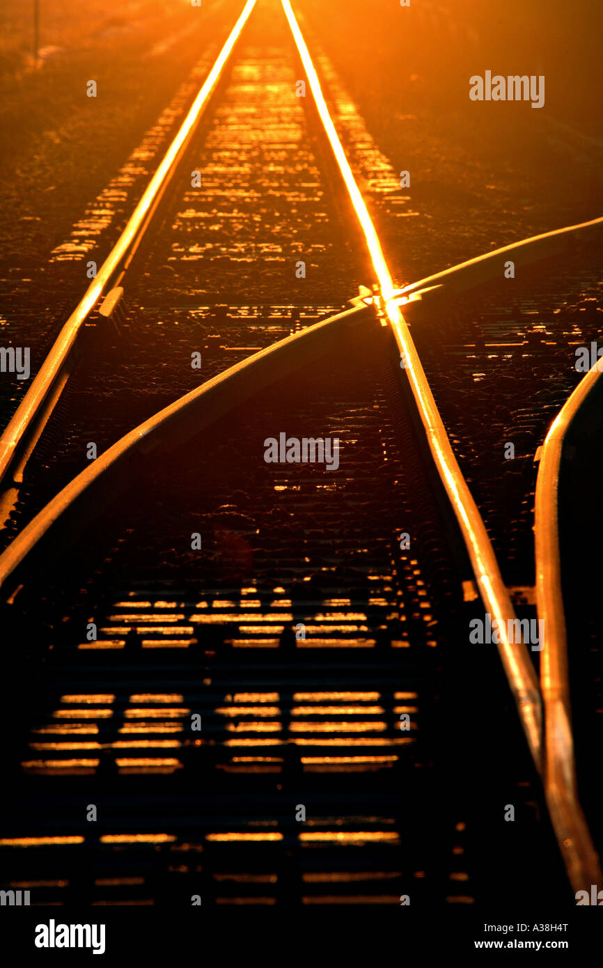 Morning sun lighting up railroad track Stock Photo - Alamy