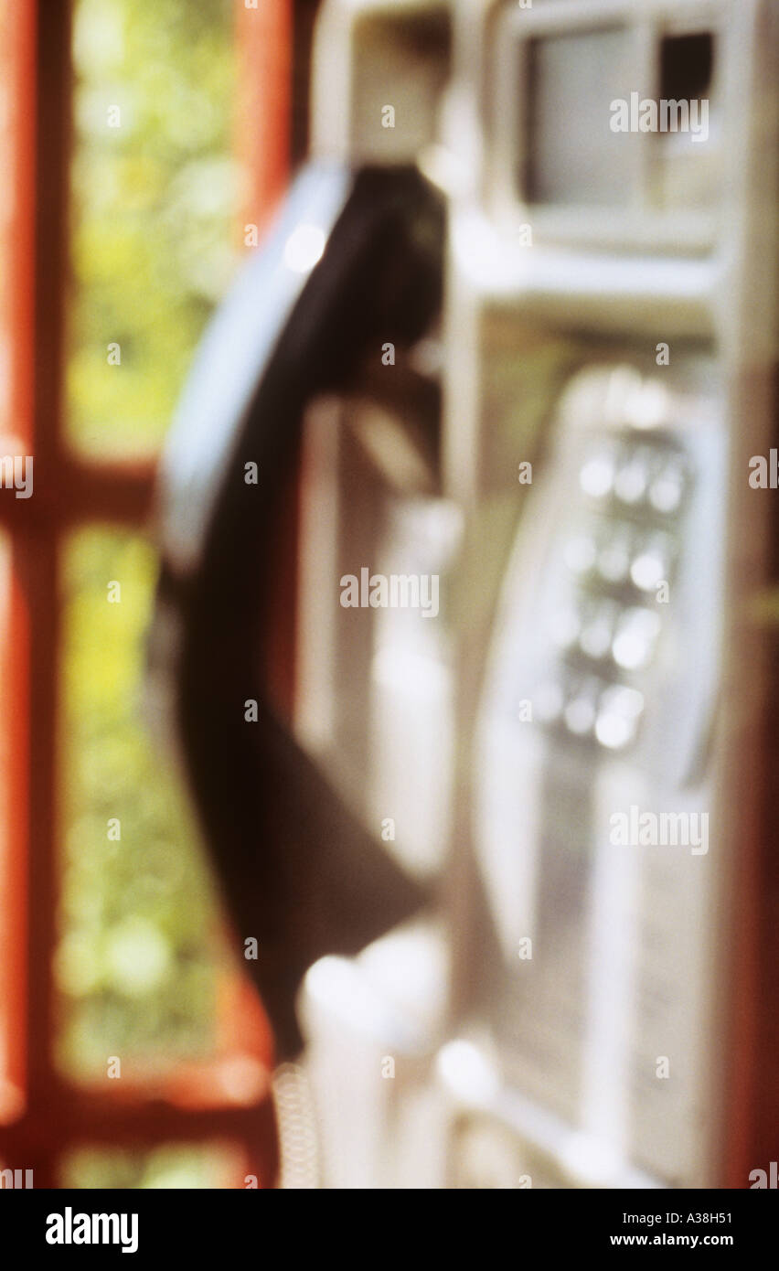 Defocussed telephone handset and keypad in a public phone kiosk or ...