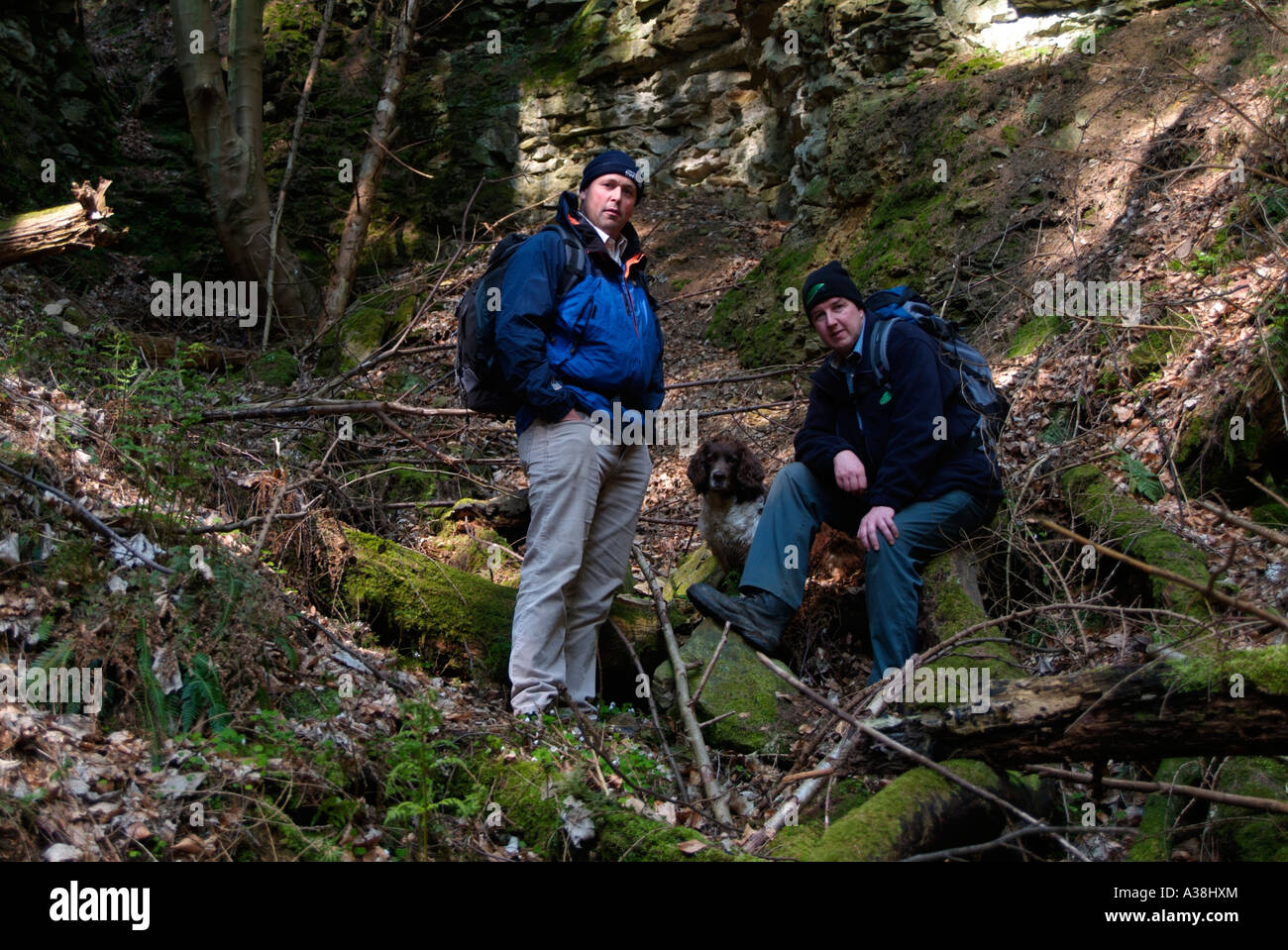 Walkers at the base of a cliff on the North York Moors with an English ...