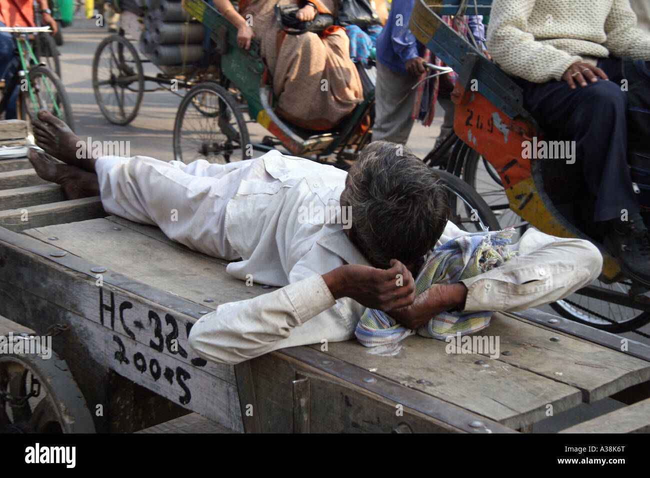 Local having a rest in the middle of a 'dual carriageway' Chandni Chowk ...