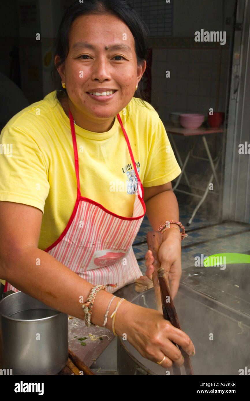 Woman cooking noodles in Penang Road George Town Penang Stock Photo - Alamy