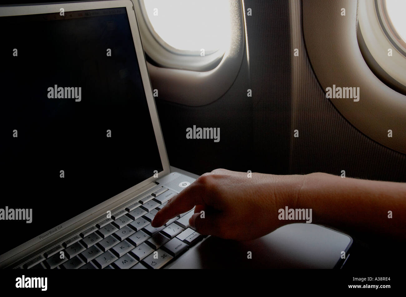 Detail of airline passenger using a laptop computer during flight Stock ...