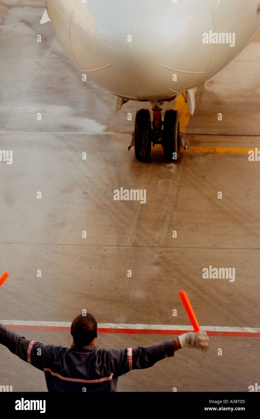 Ground crewman guiding an aircraft Stock Photo - Alamy