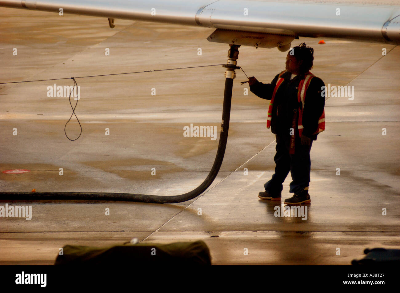 Female ground crewman refueling aircraft before takeoff Stock Photo - Alamy