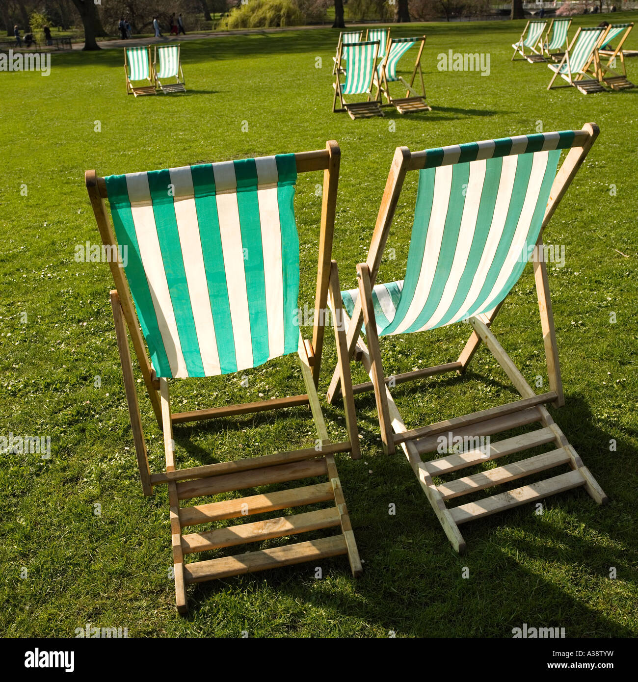Green folding chairs in the sun at St. James Park London England UK ...
