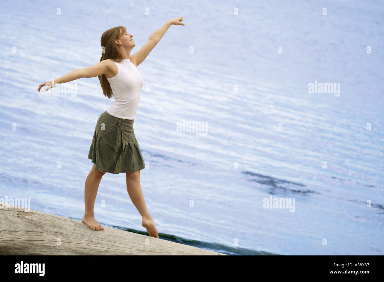 Woman balancing on log Stock Photo - Alamy