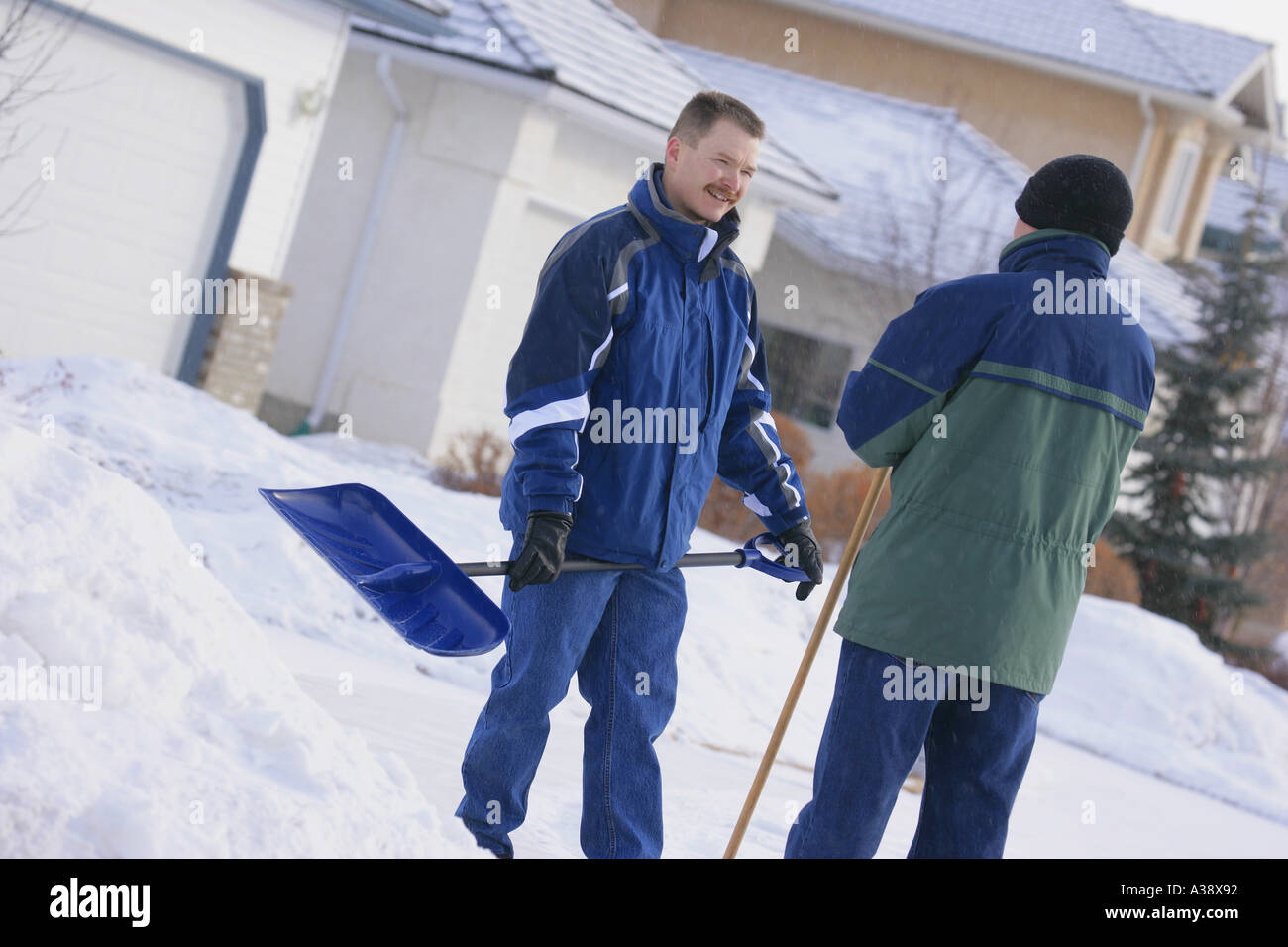 Men shoveling snow Stock Photo - Alamy