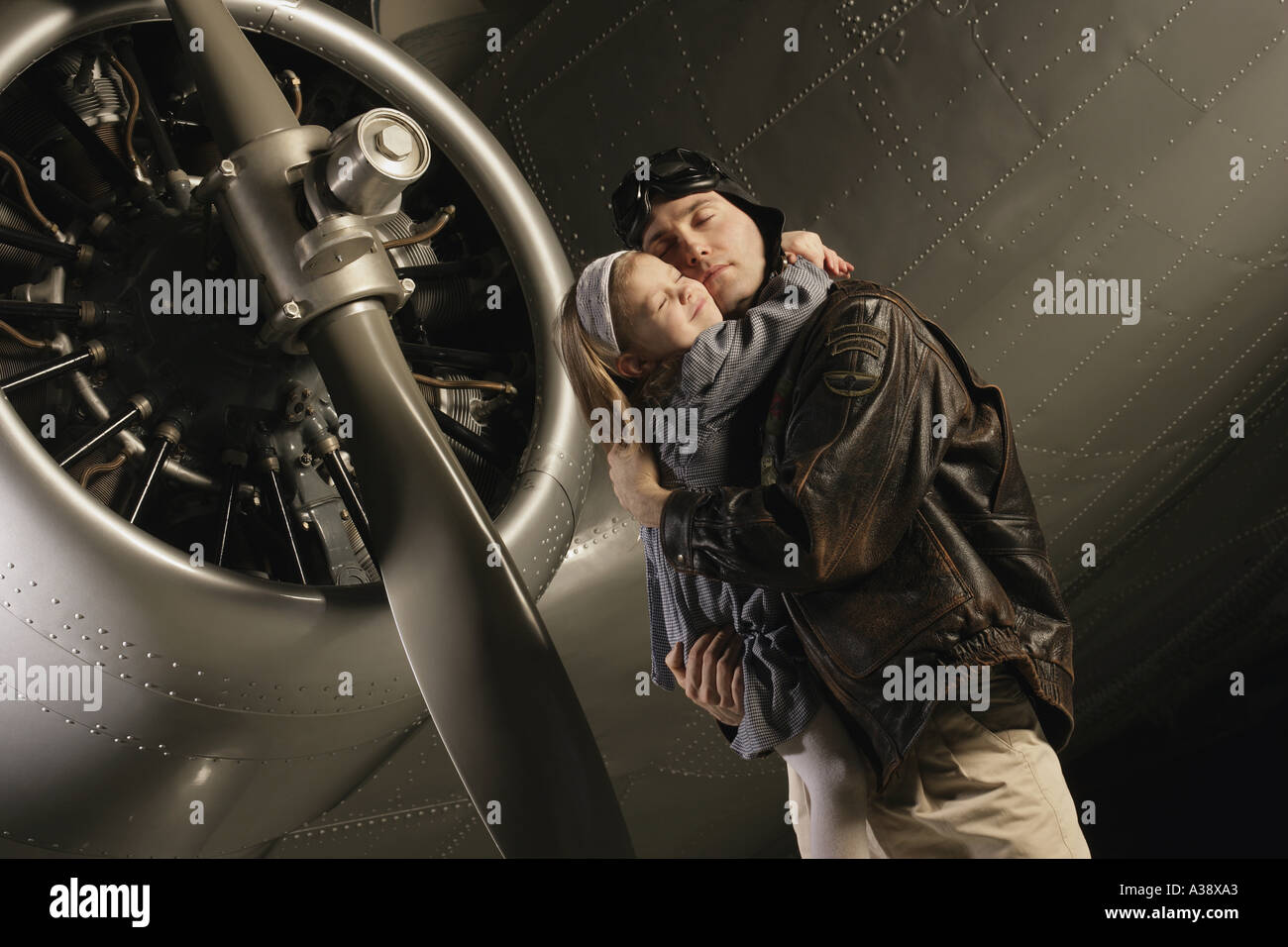 Pilot hugging child Stock Photo - Alamy