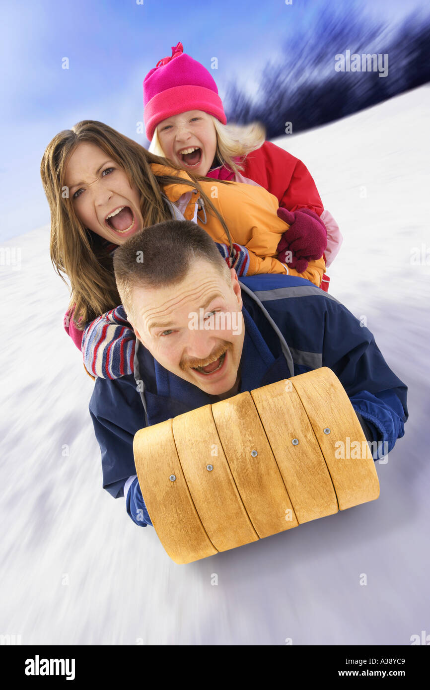 Family on sled Stock Photo - Alamy