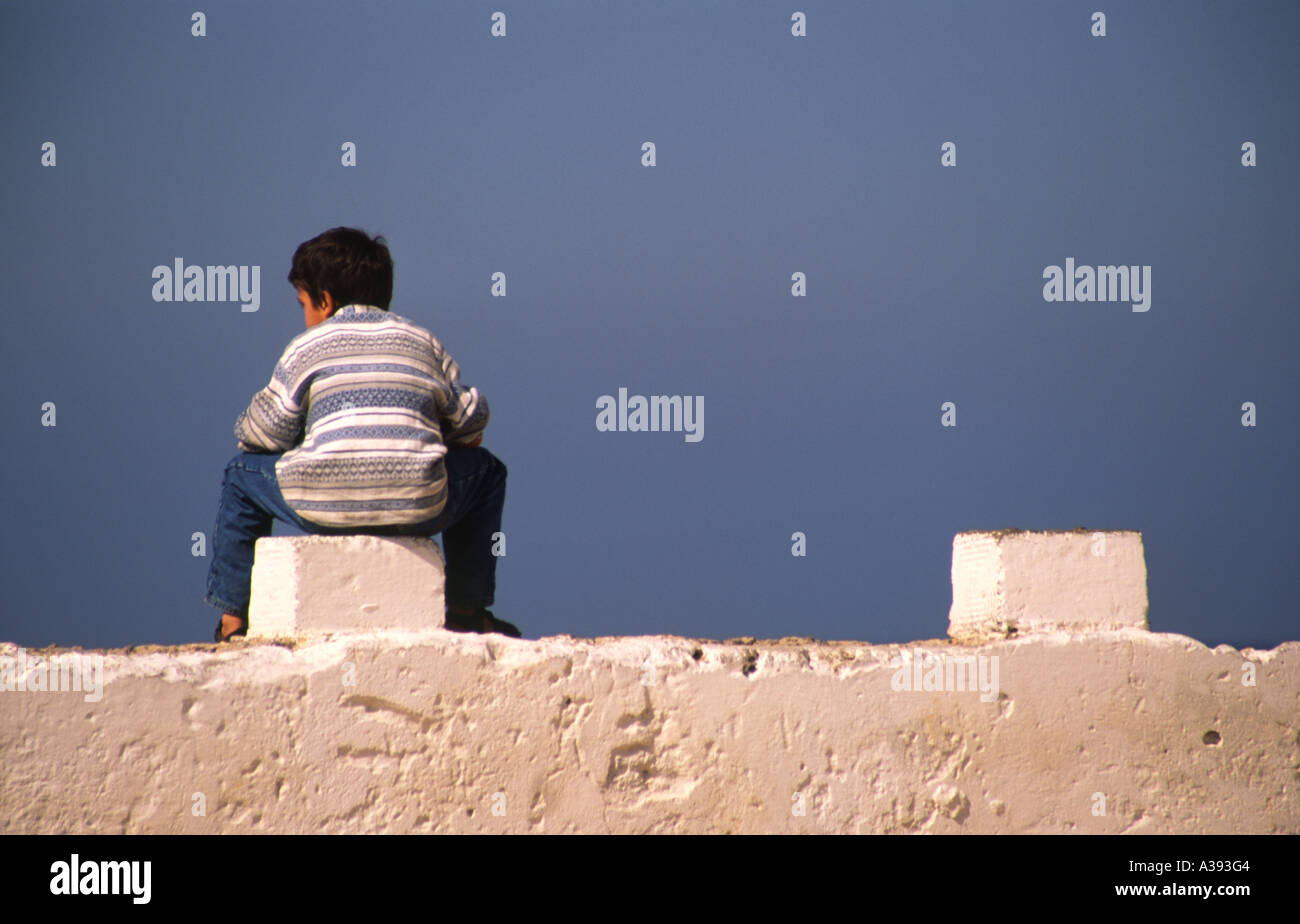Boy sitting on the rampart walls in Essaouira, Morocco , North Africa ...