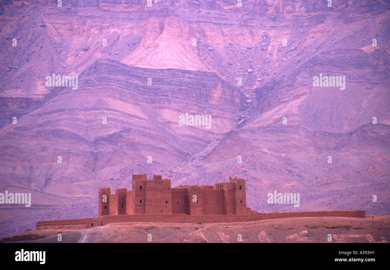 Horizontal landscape detail with kasbah against steep cliff face ...