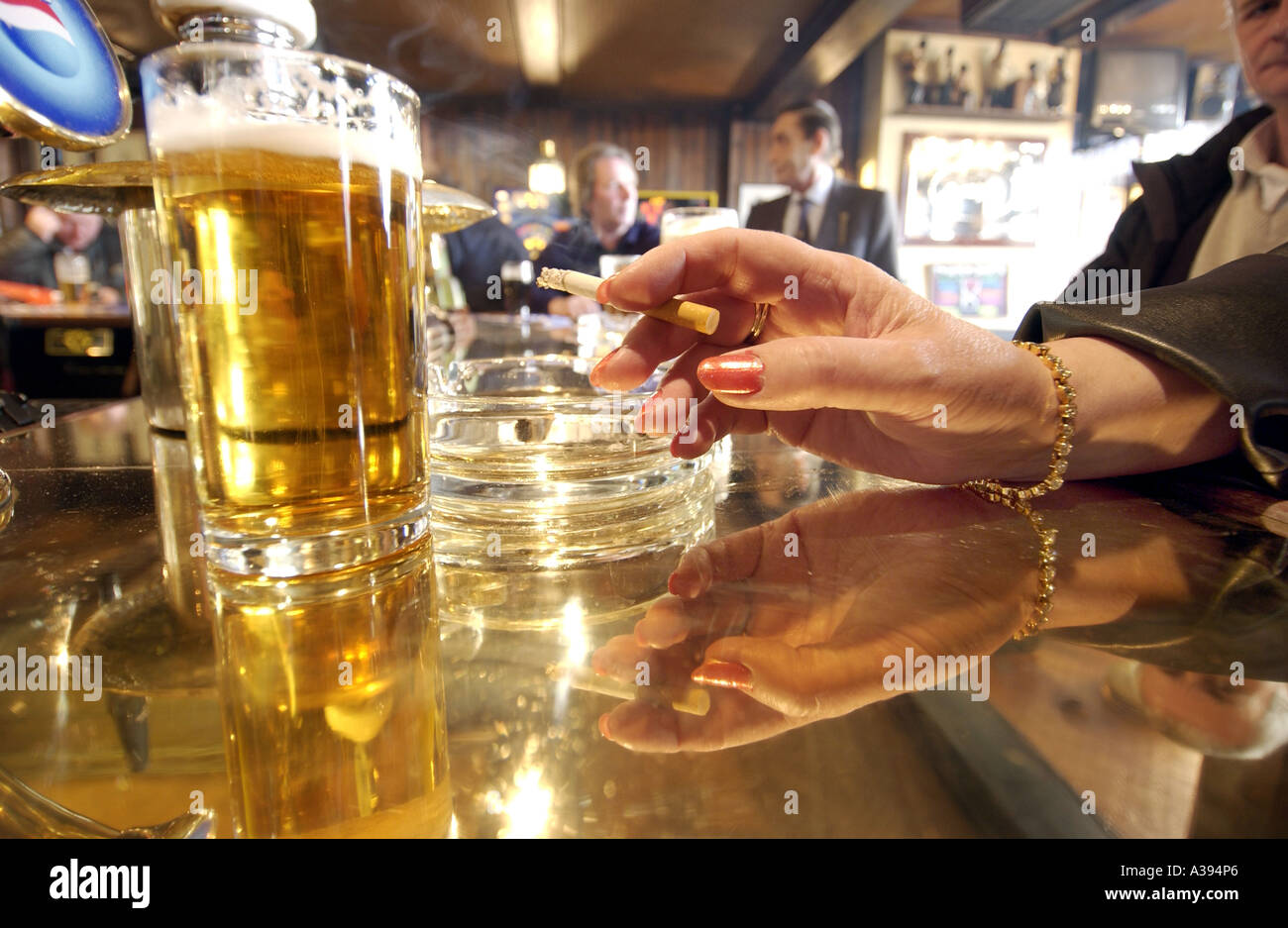 Hand holding cigarette beer glass hi-res stock photography and images ...