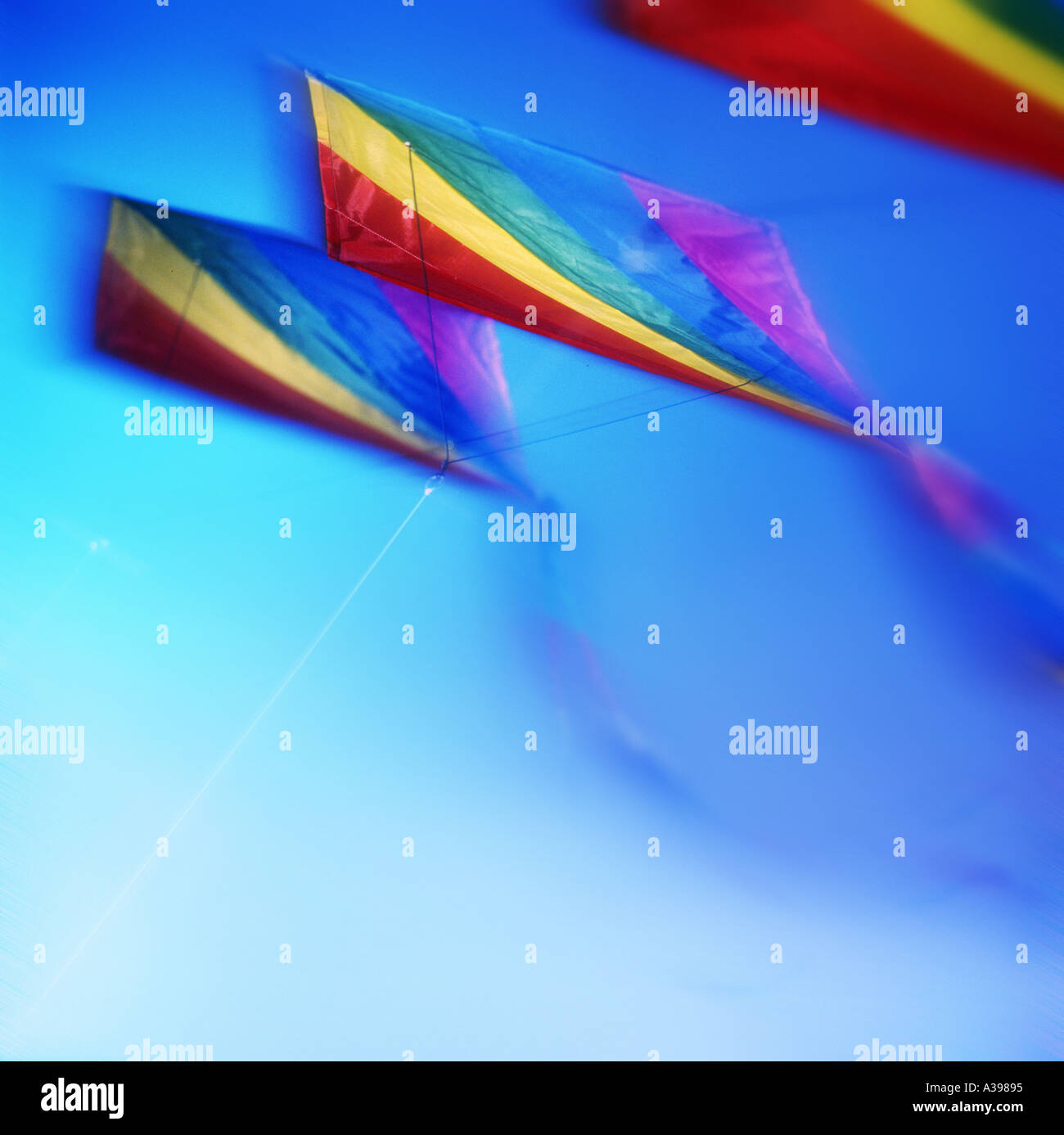 Three kites floating in a blue sky Stock Photo - Alamy