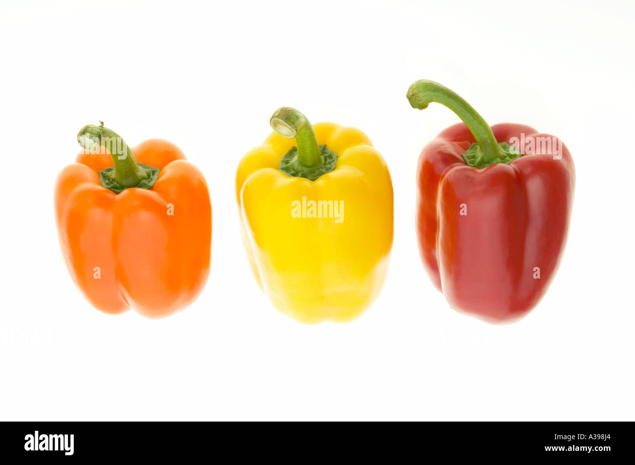 Three capsicums in white background Stock Photo - Alamy