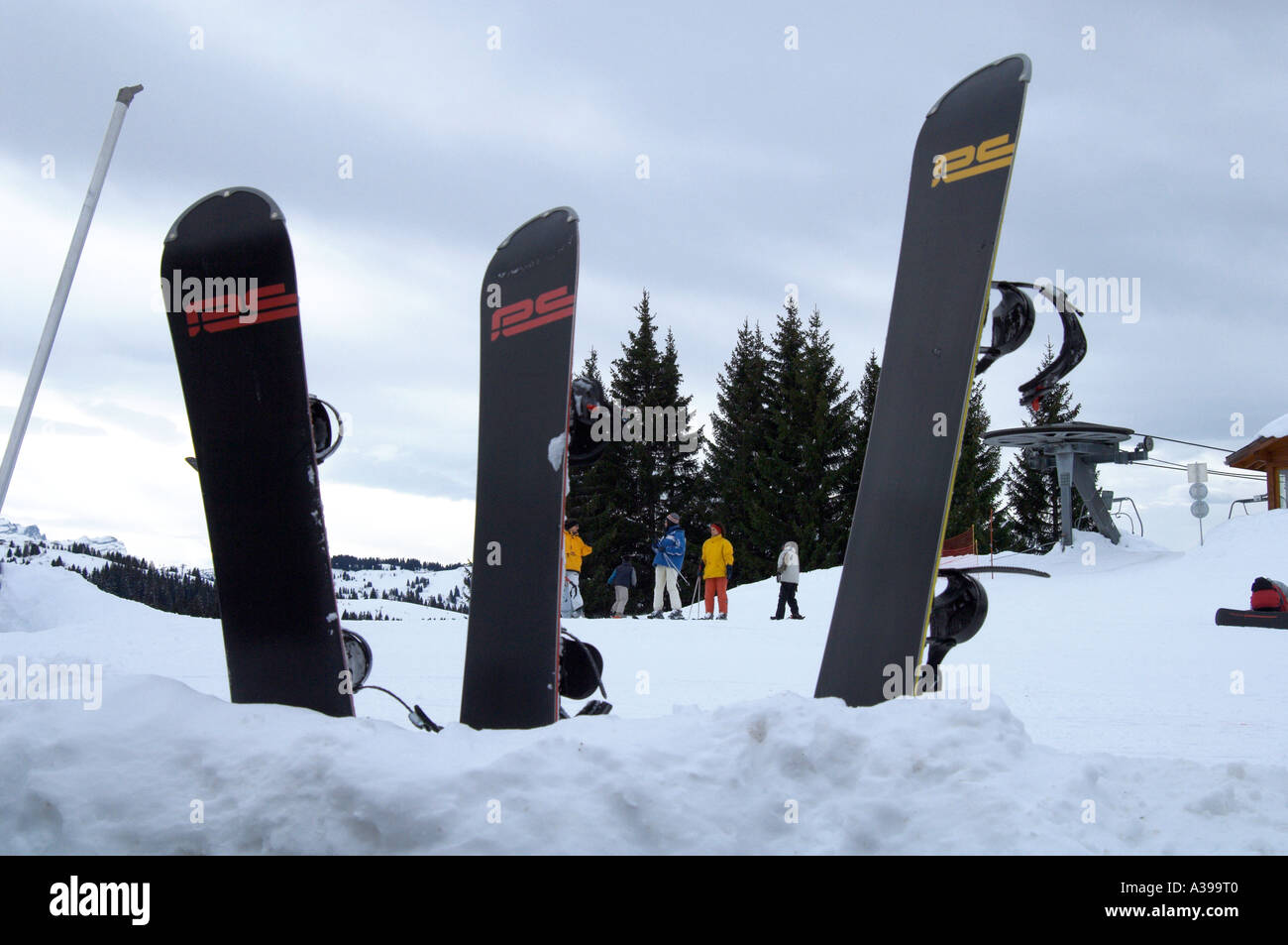 snowboards sticking out of the snow Stock Photo - Alamy