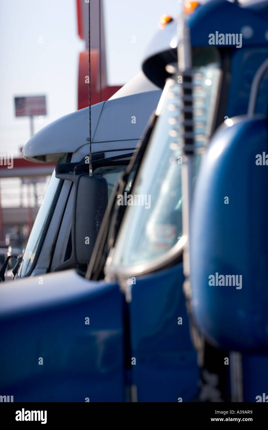 Close up side view of two tractor trailer trucks at truck stop Stock ...