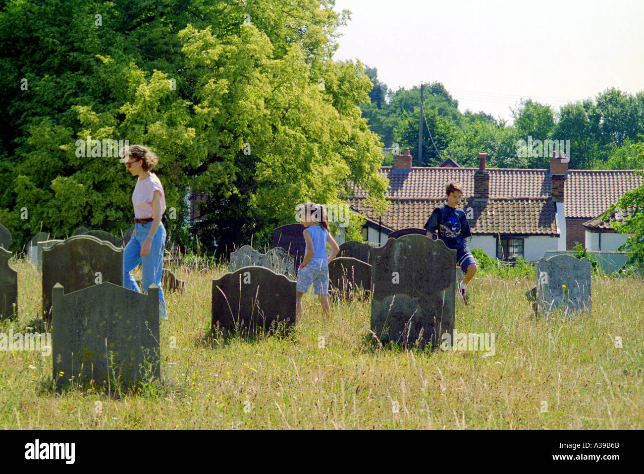 Woman and boy and girl and Grave Stones Stock Photo - Alamy
