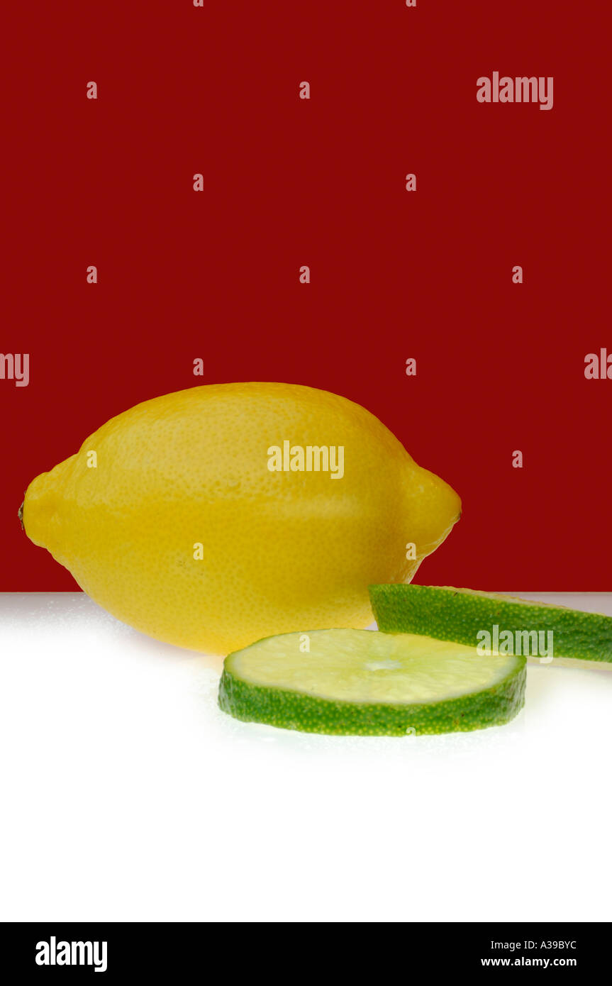 Lemon and Limes on a red and green background Stock Photo - Alamy