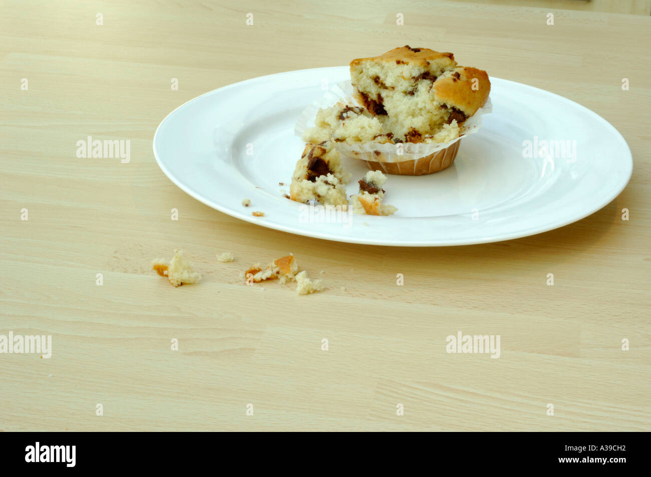 Broken muffin with Crumbs Stock Photo - Alamy