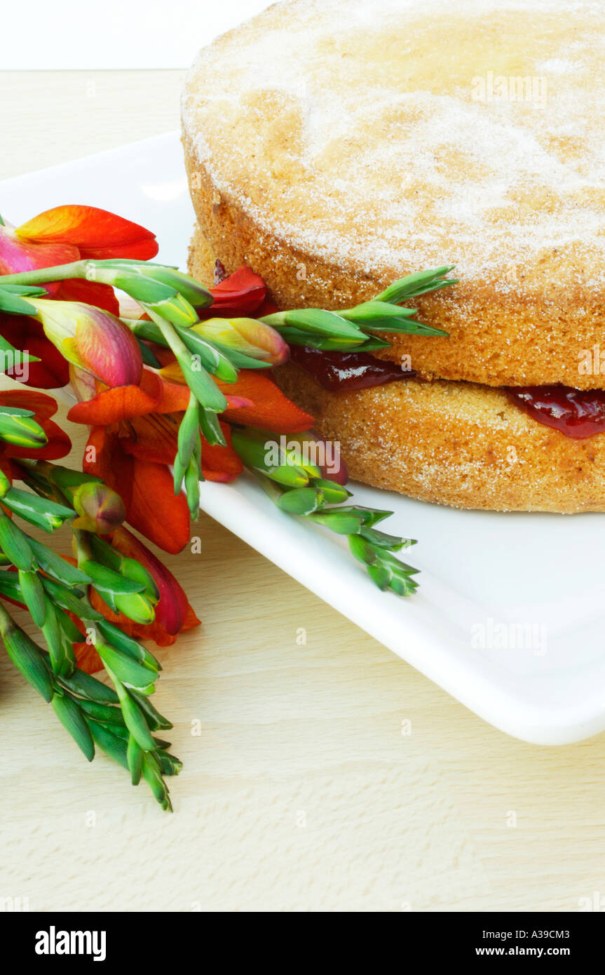 Jam Sponge cake and flowers Stock Photo - Alamy