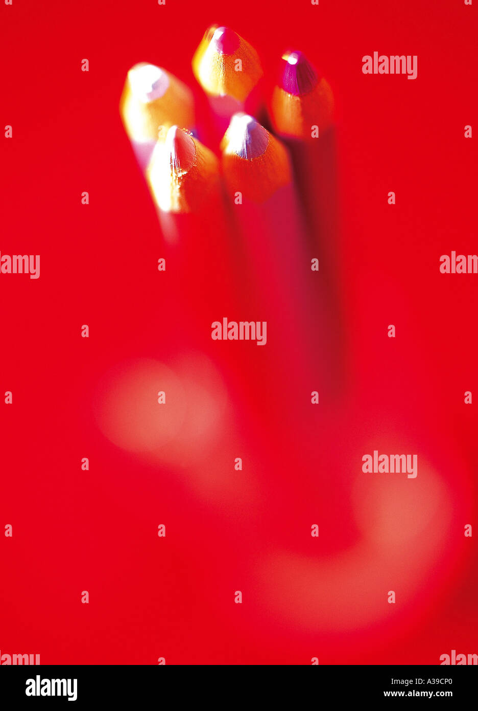 five color pencils and red background Stock Photo - Alamy