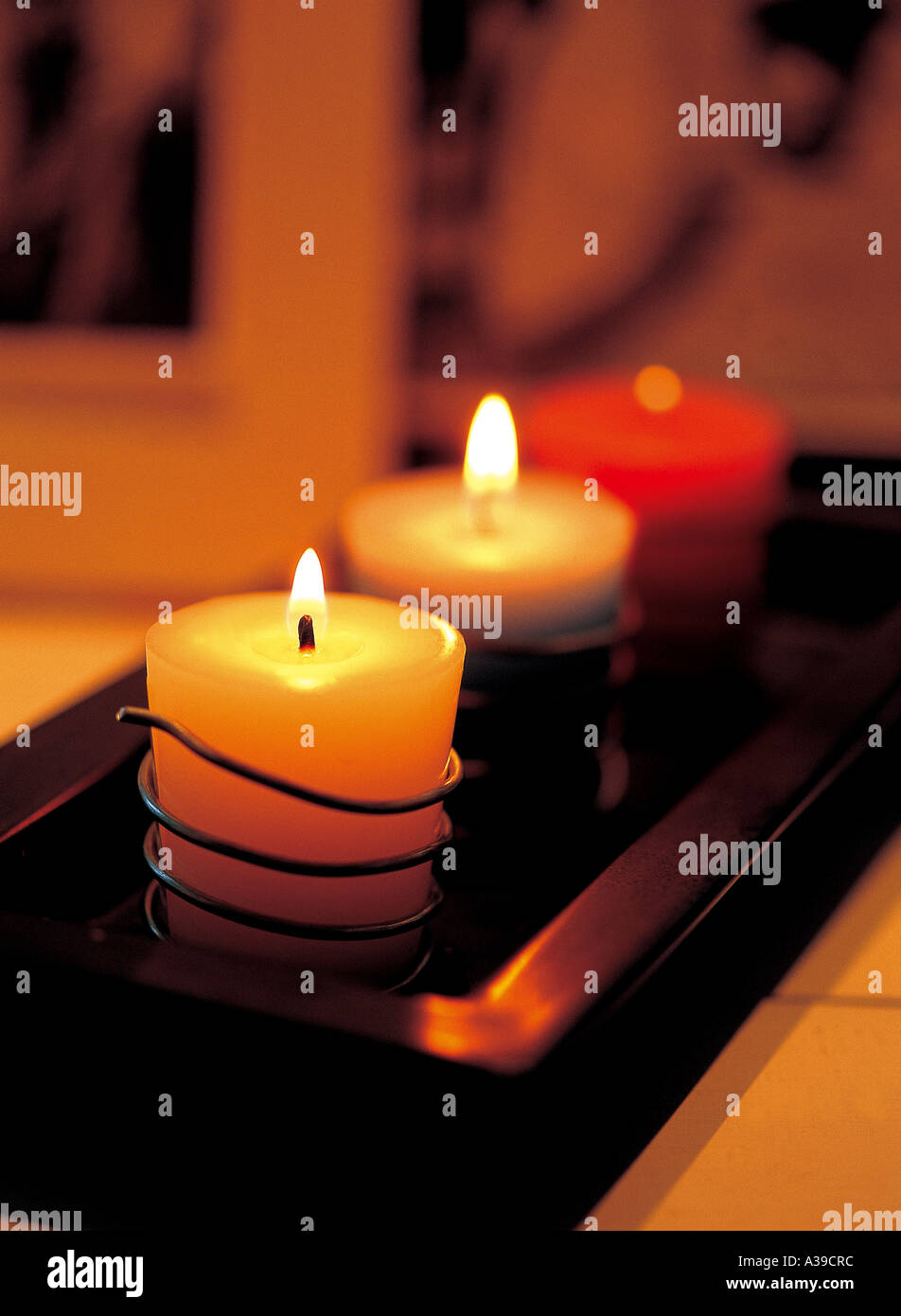 three candle lights shining Stock Photo - Alamy
