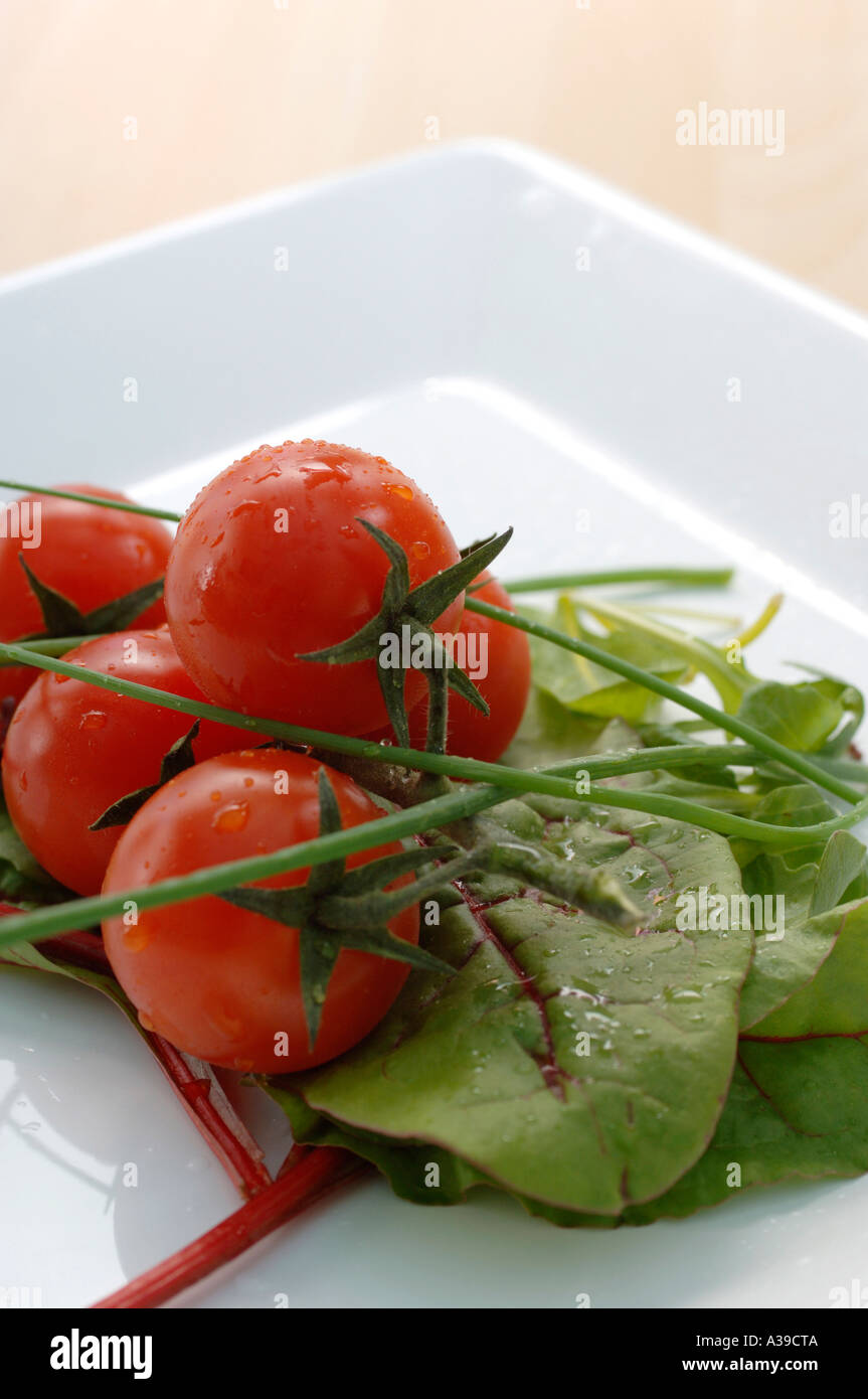 Vine ripened tomatoes and Swiss Chard salad with chives Stock Photo - Alamy