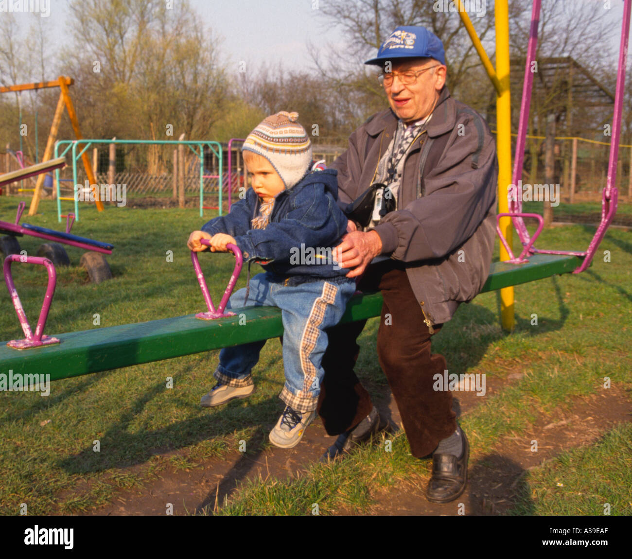 Swinging with grandpa Stock Photo - Alamy