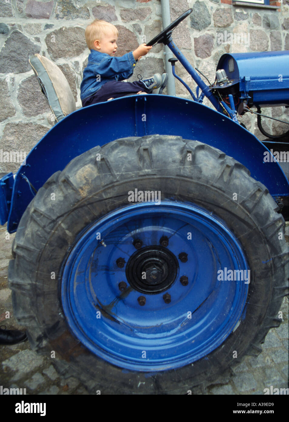 Driving a tractor Stock Photo - Alamy