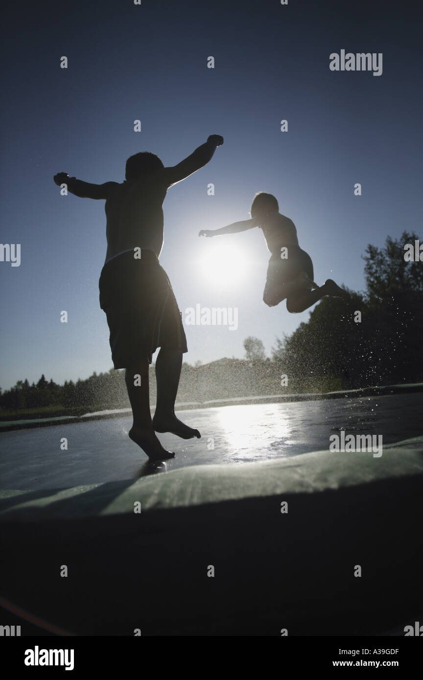 Silhouettes two children playing on hi-res stock photography and images ...