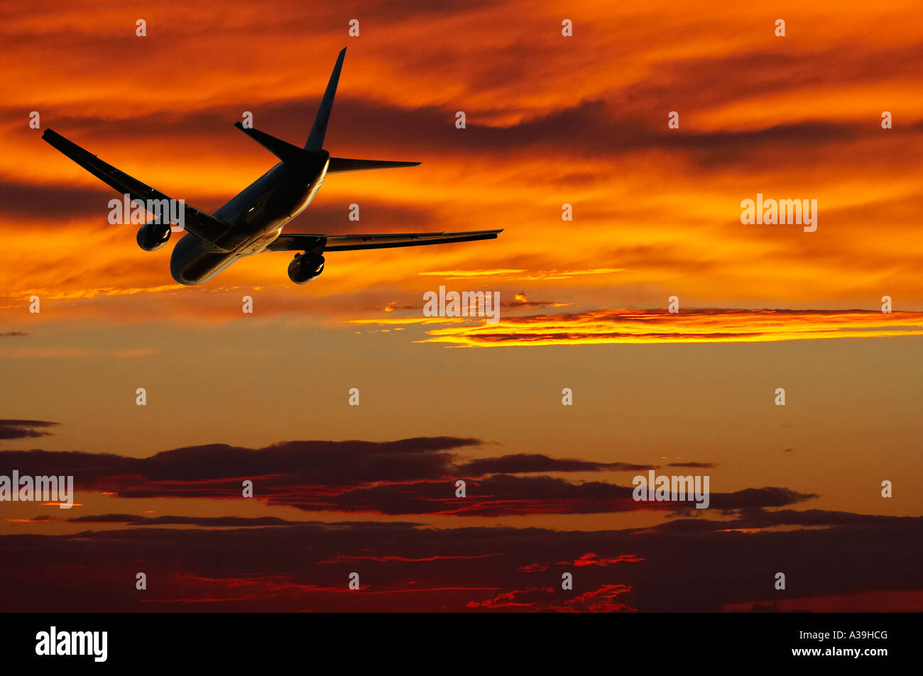 Airplane taking off into a sunset Stock Photo - Alamy