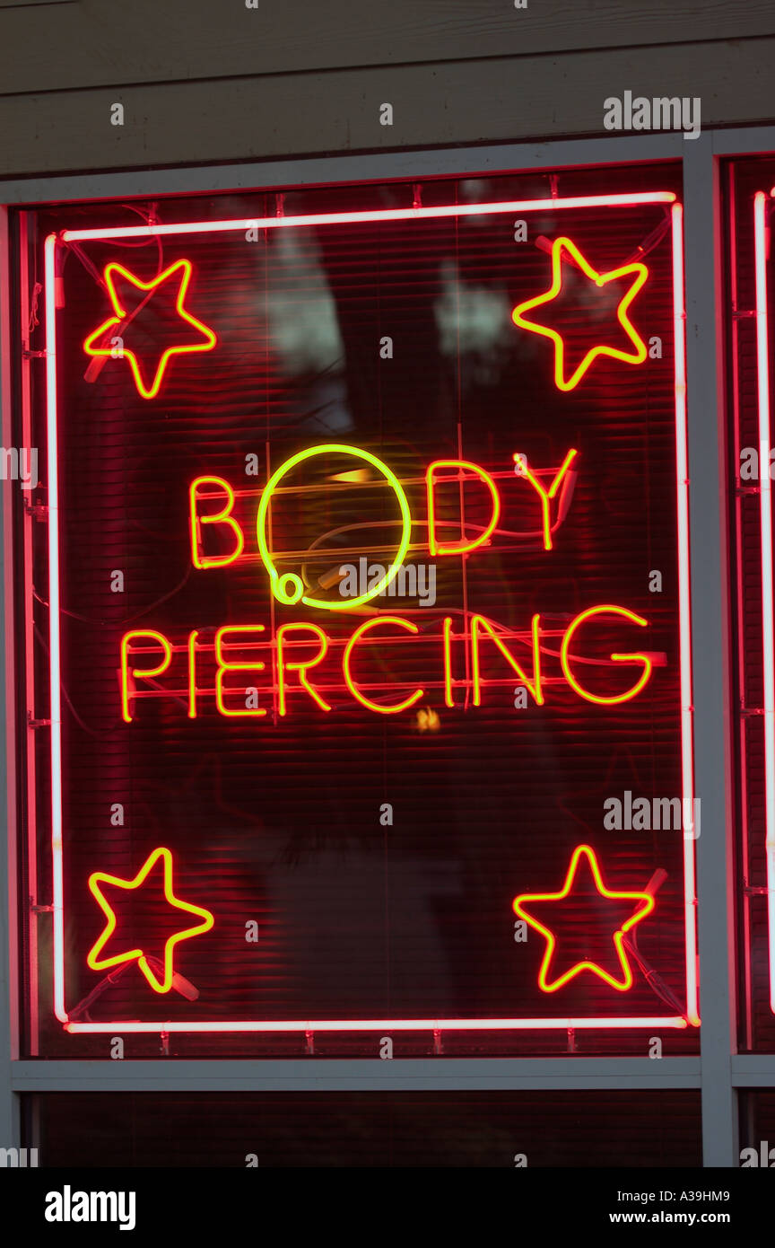 neon body piercing sign Stock Photo - Alamy