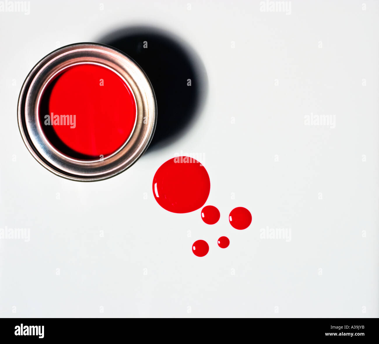 Red paint tin with drops of spilt paint on clean white background Stock ...