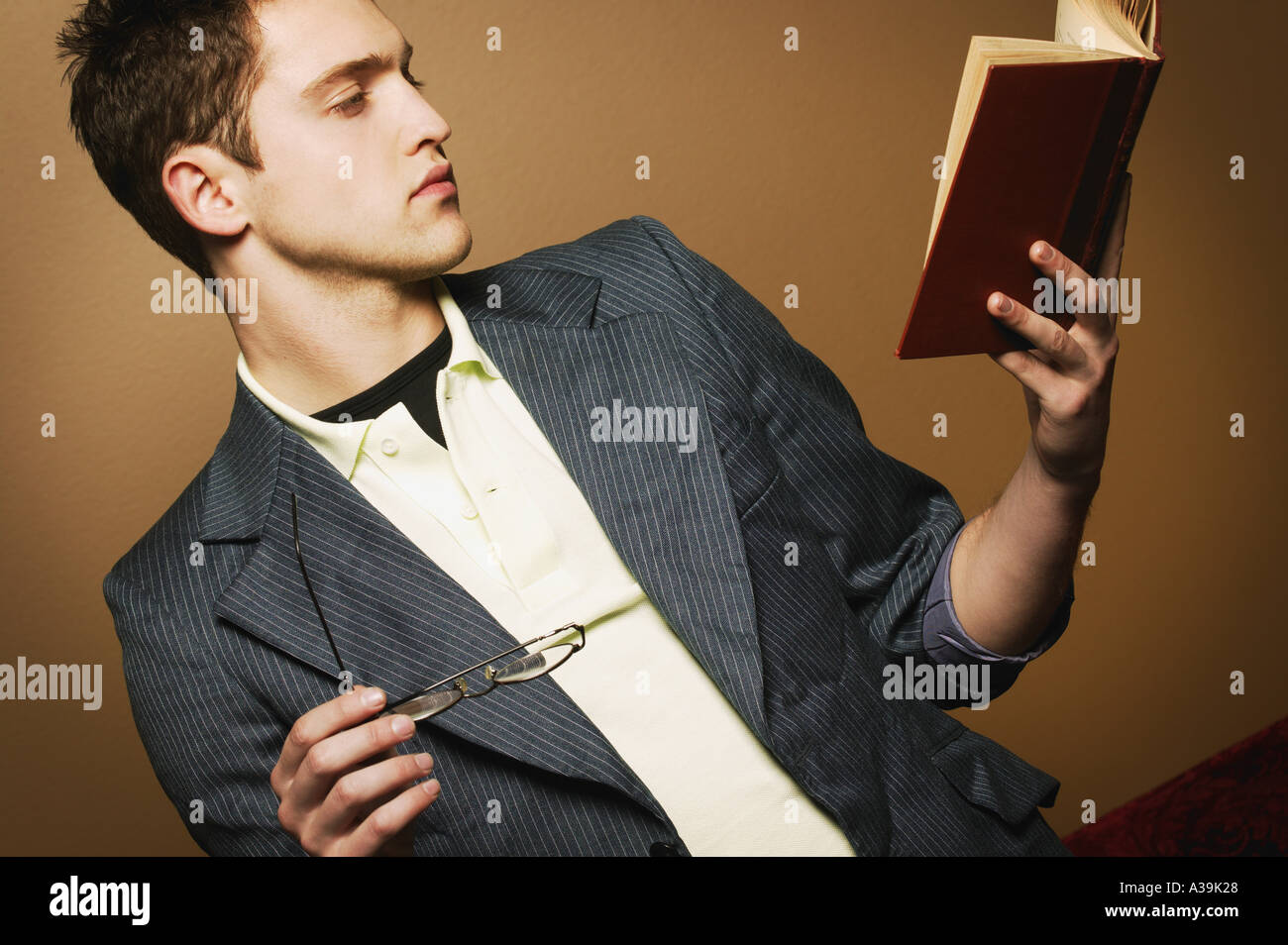 Studious teenager reading book hi-res stock photography and images - Alamy
