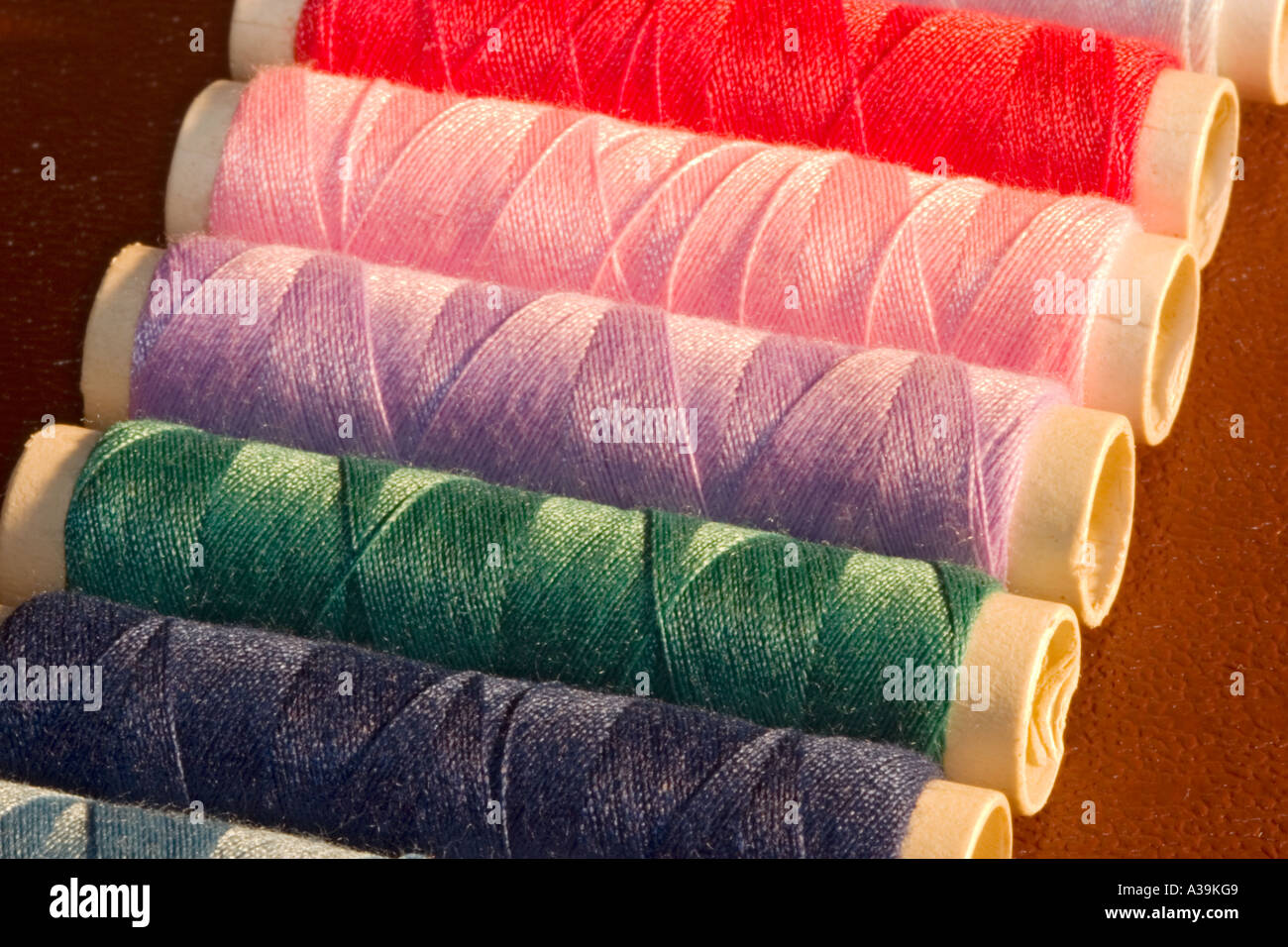 Close up of different coloured sewing threads on leather Stock Photo ...