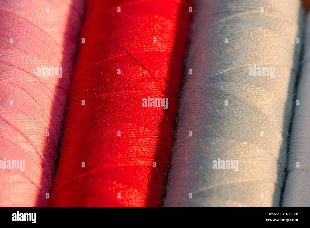 Close up of different coloured sewing threads Stock Photo - Alamy
