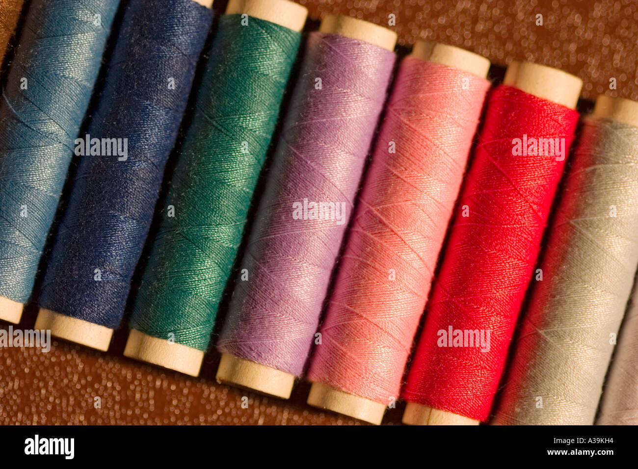 Close up of different coloured sewing threads on leather Stock Photo ...