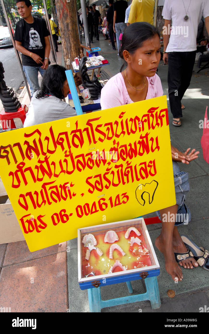 Woman selling false teeth in street market Bangkok Thailand Stock Photo ...
