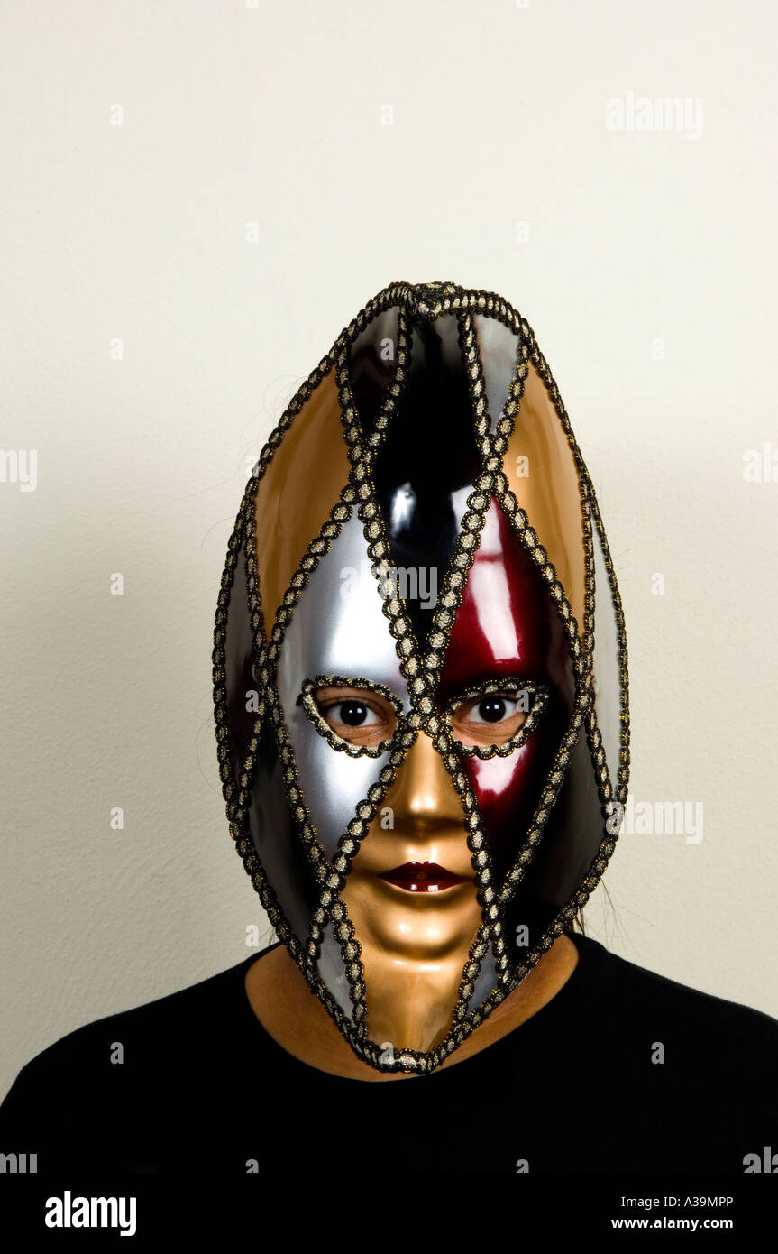 Woman hiding behind a mask Stock Photo - Alamy